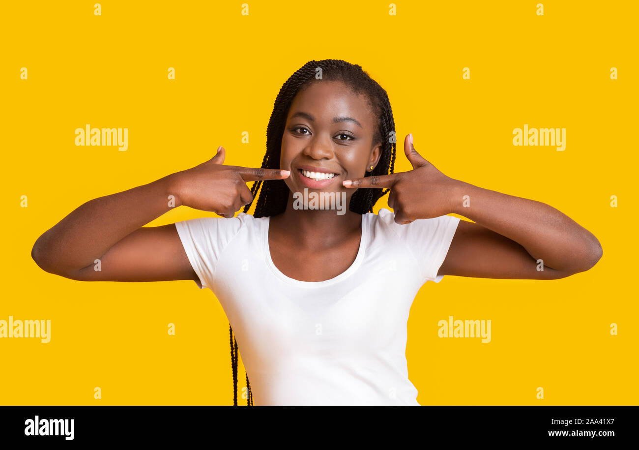 Black girl smiling and showing perfect teeth Stock Photo - Alamy