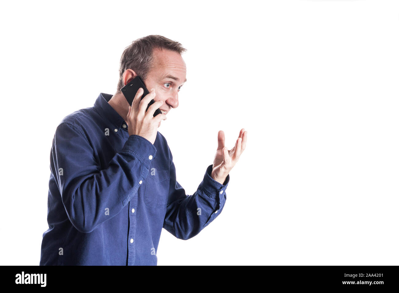 Confused man holding mobile Cut Out Stock Images & Pictures - Alamy
