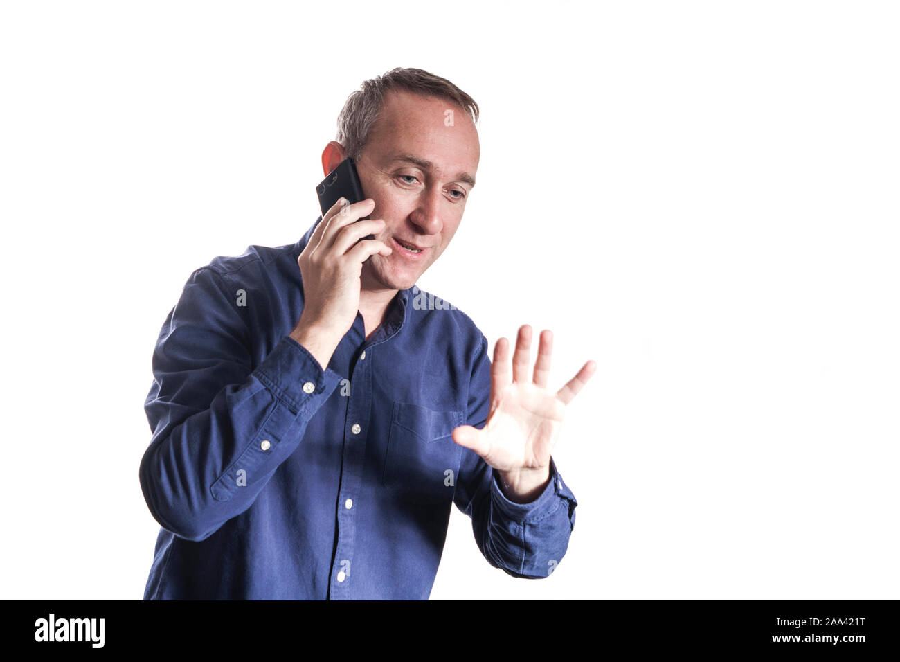 Confused man holding mobile Cut Out Stock Images & Pictures - Alamy