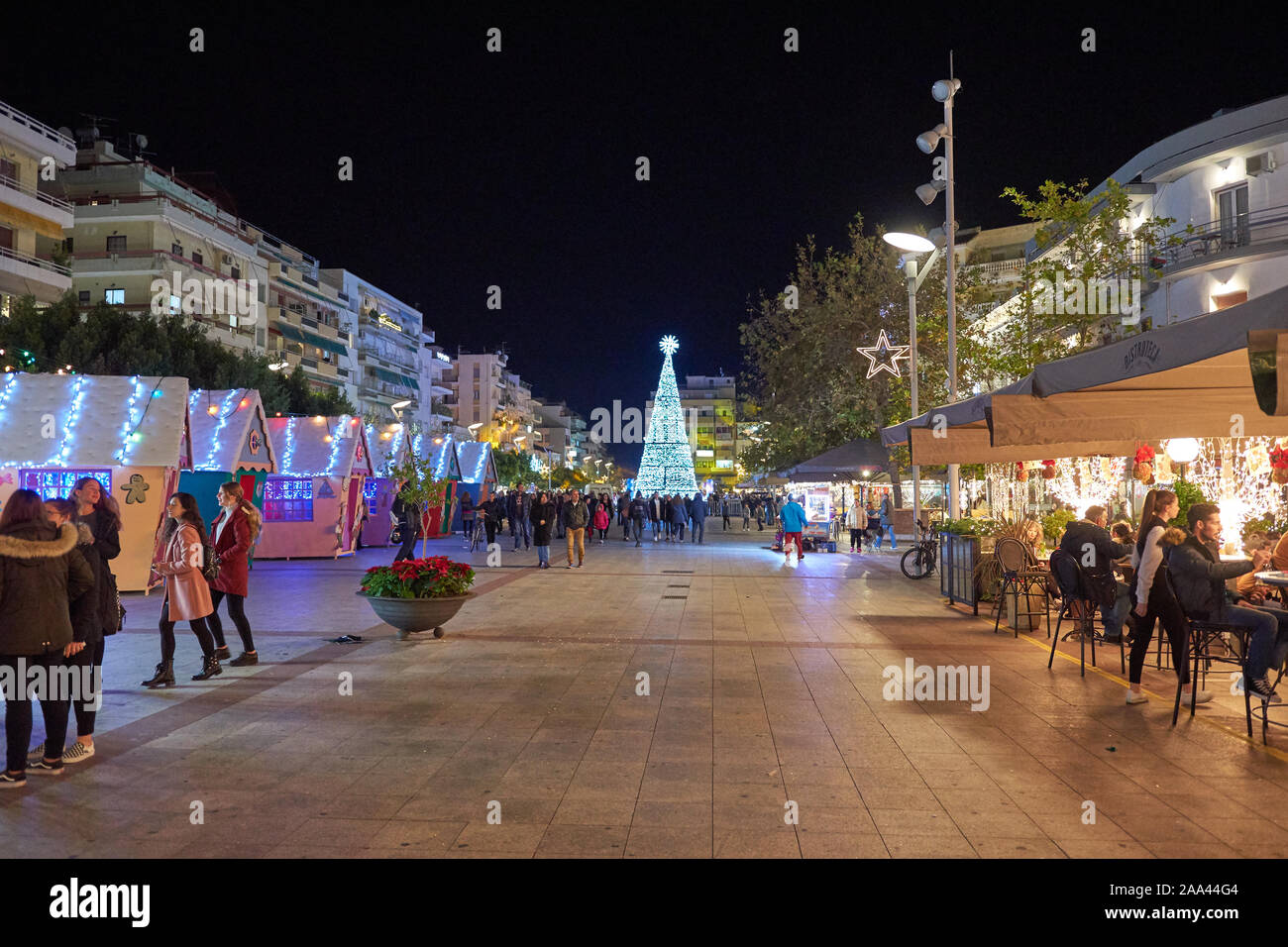 Christmas atmosphere in Kalamata, Greece with people walking by the ...