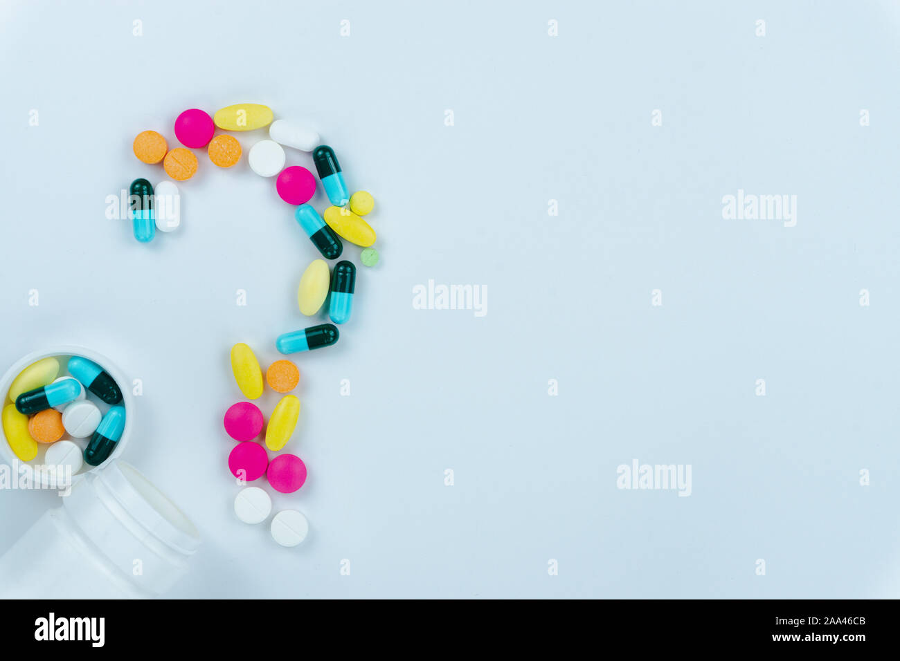 Assorted pharmaceutical medicine pills with question sign, tablets and ...