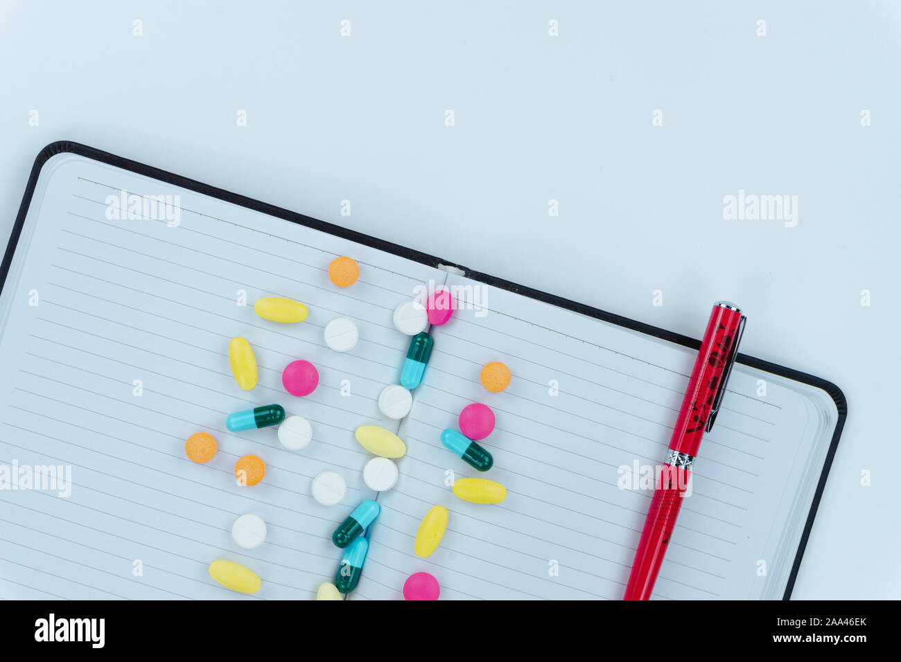 Assorted pharmaceutical medicine pills, tablets and capsules, pen and ...