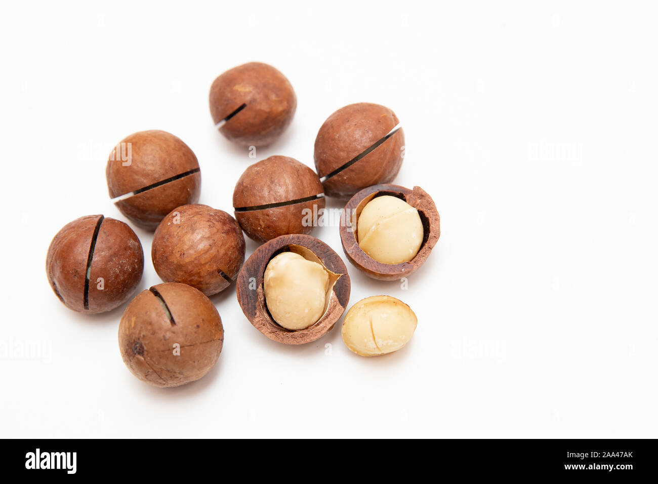 Pile macadamia nuts open kernels and shells on white background, top ...