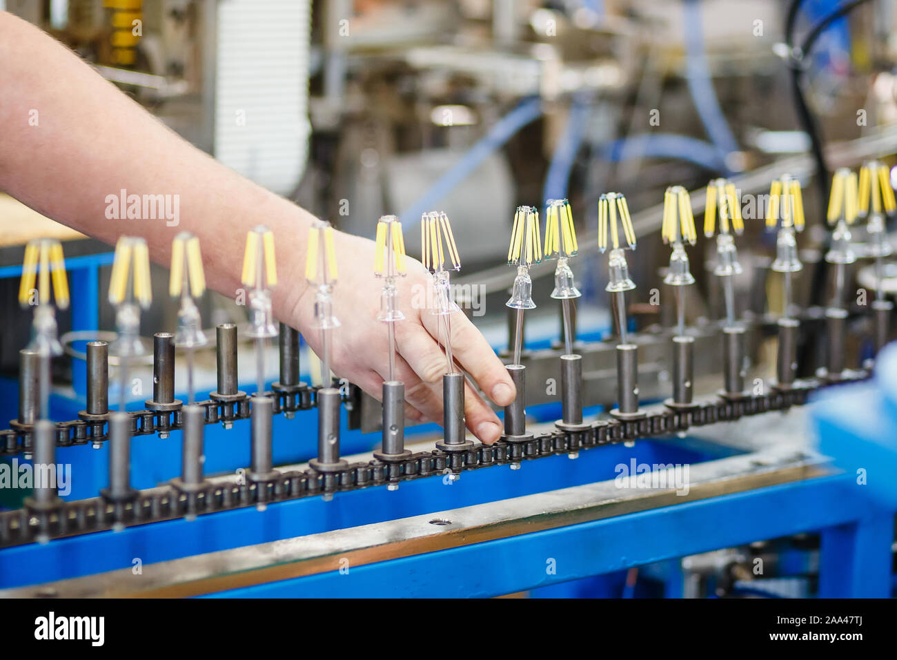 Worker hands picks up electric glass lamp, put cap on wires Stock Photo ...