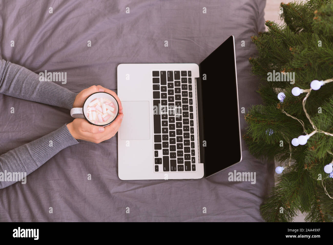 Woman near christmas tree using hi-res stock photography and images - Alamy
