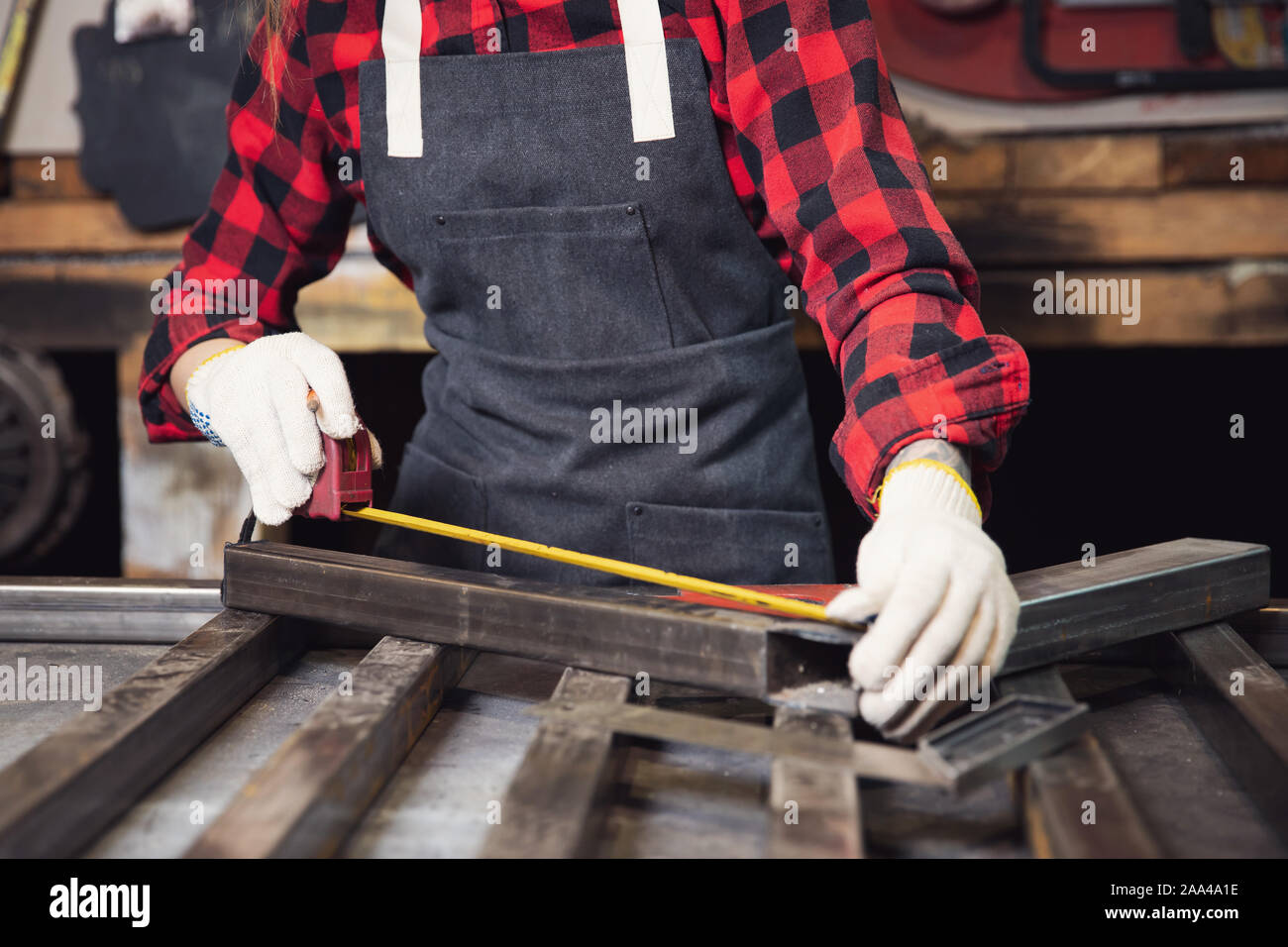 Engineer works with metal structures use with ruler Stock Photo - Alamy