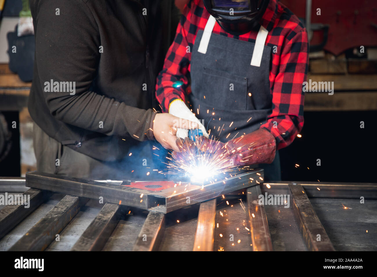 Male teacher master class welding and work student of technical school ...