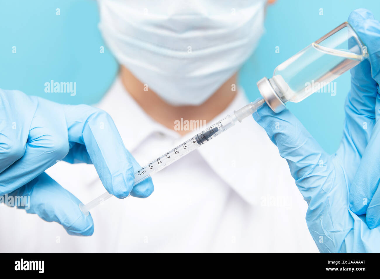 Beauty spa doctor holding syringe on blue background. Concept lip ...