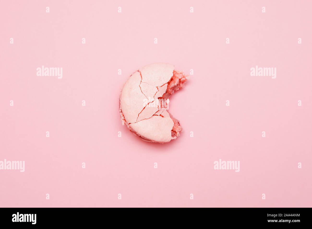 Minimalism, bitten macaroons on pink background, top view Stock Photo ...