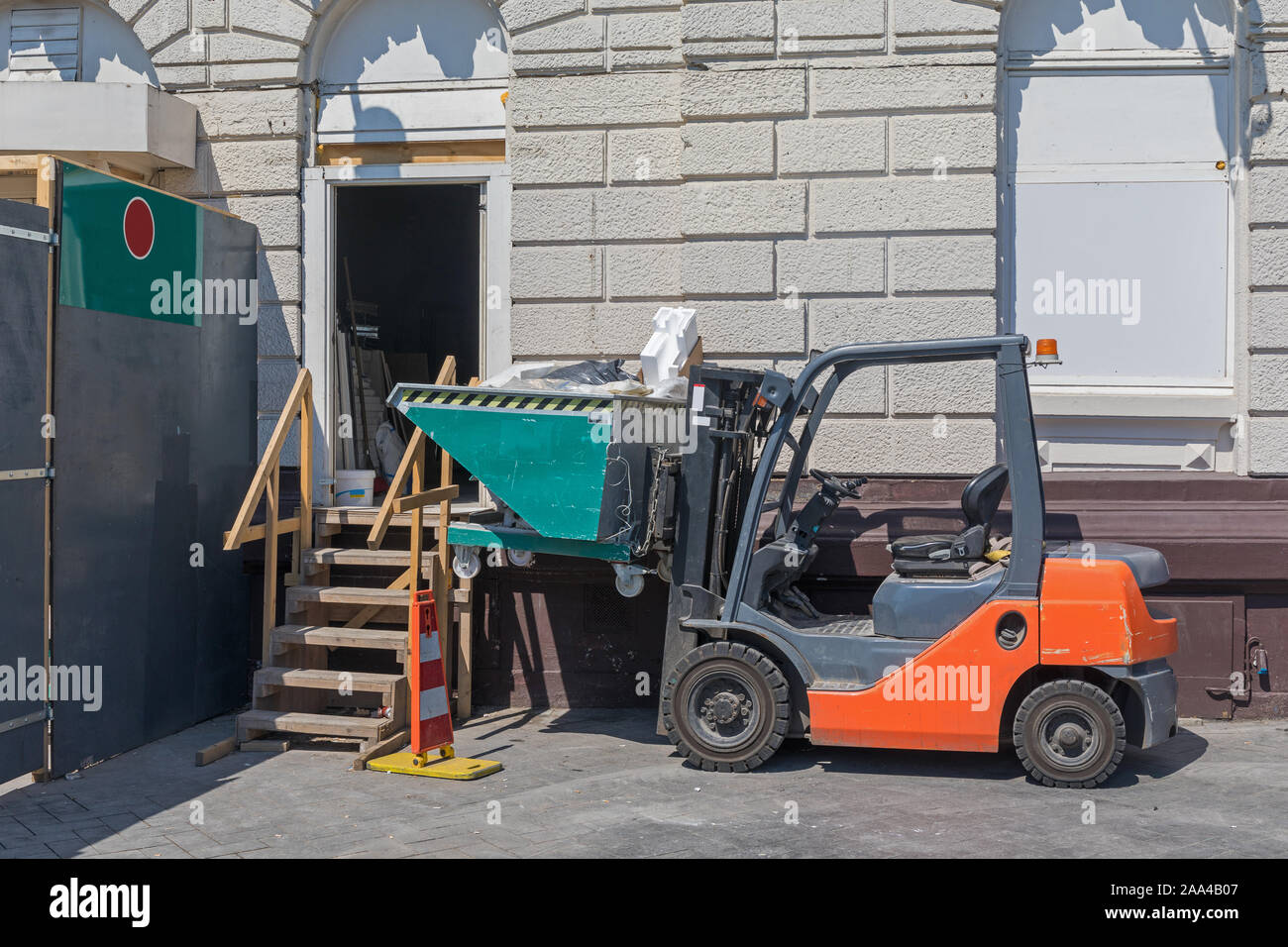 Forklift Truck With Skip Container at Construction Site Stock Photo - Alamy