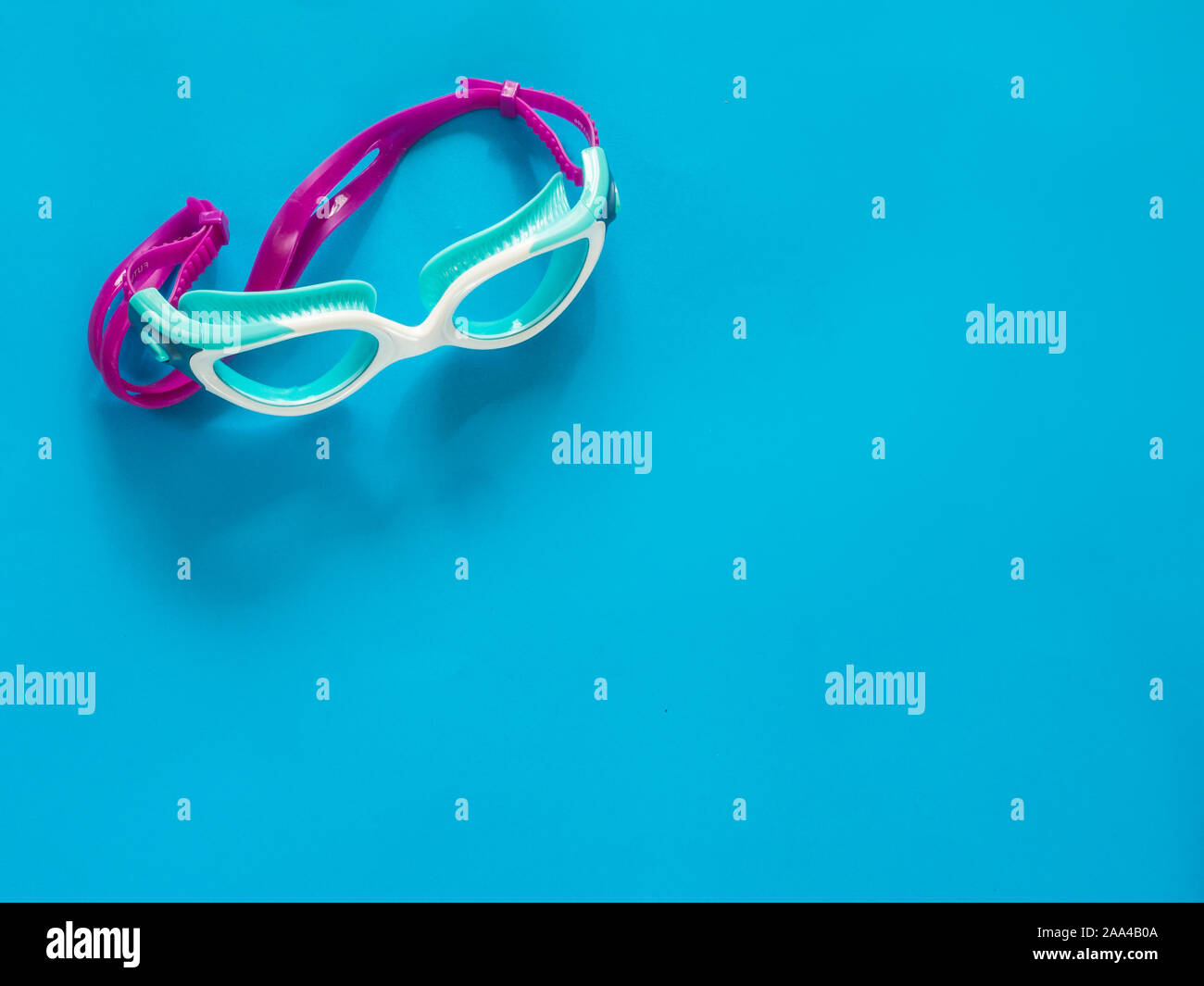 Swimming pool glasses on blue background with copy space Stock Photo ...