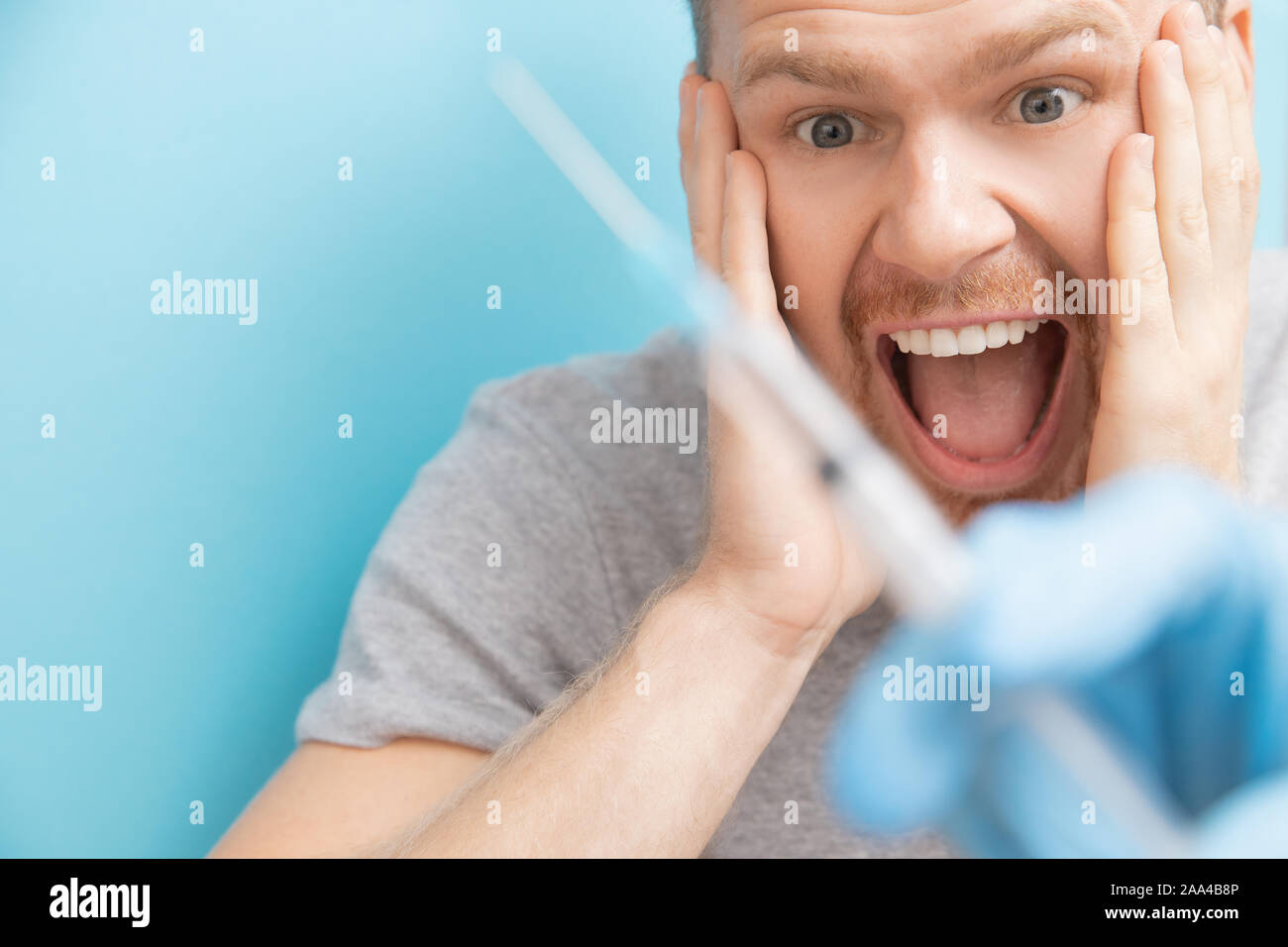 Fear of syringe injections and vaccinations doctor appointment. Man is ...