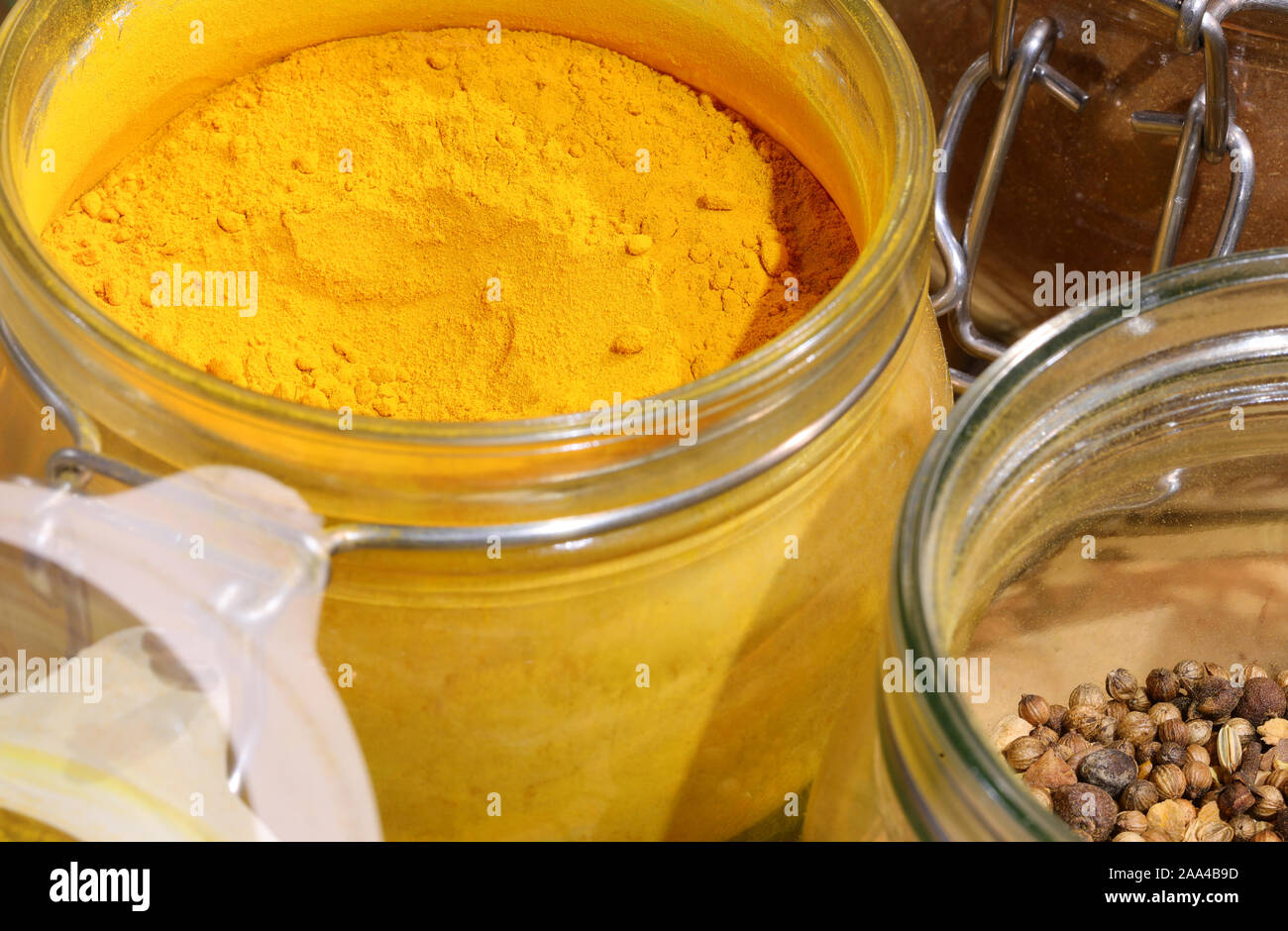 yellow curry powder and peppercorns in the glass jar Stock Photo - Alamy