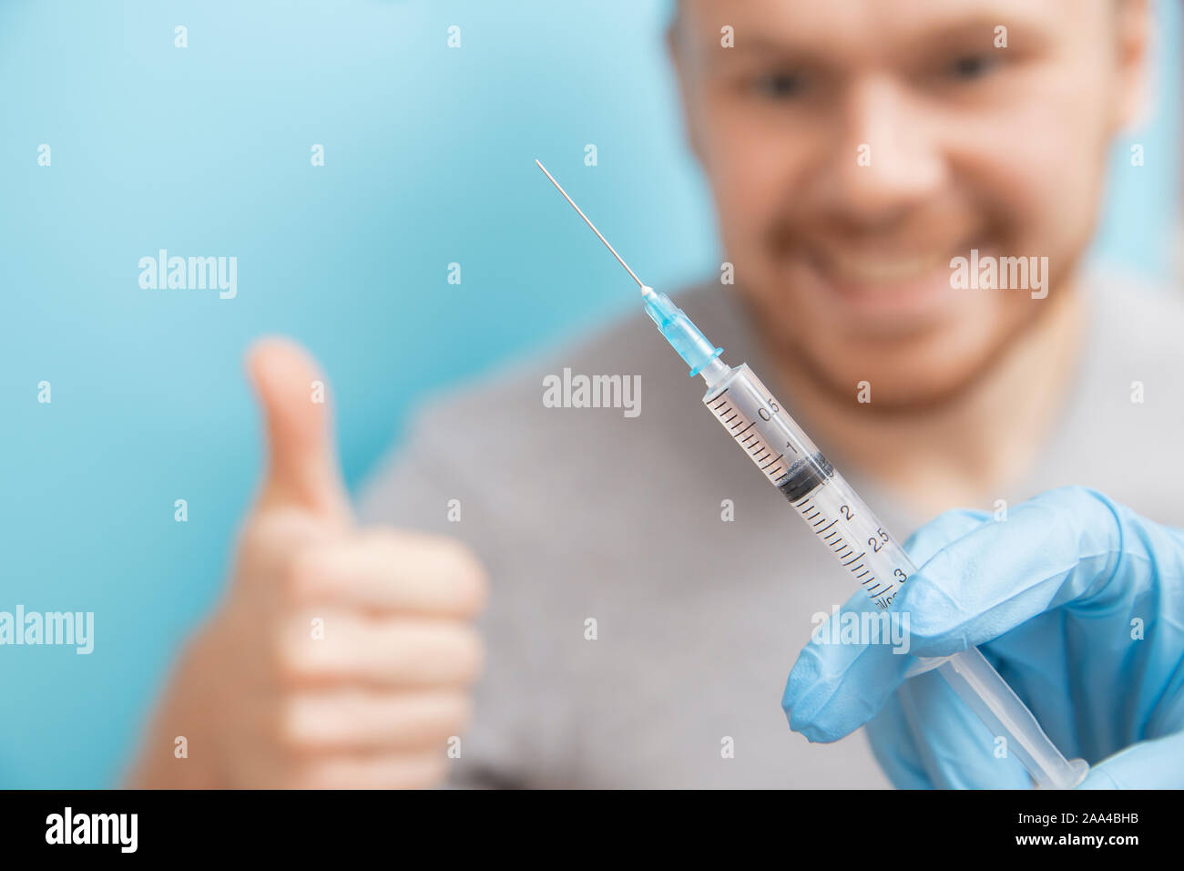 Doctor gives man syringe with vaccine in shoulder for colds and flu ...