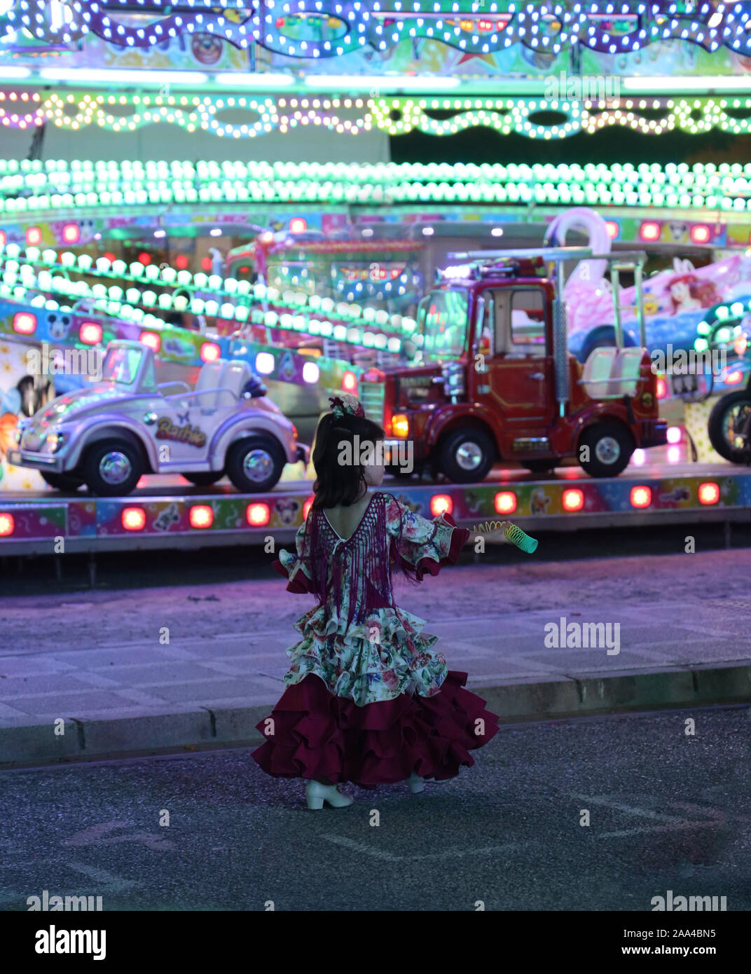 Fun Fair. Fairground rlde/stall. Girl in traditional Flamenco dress ...