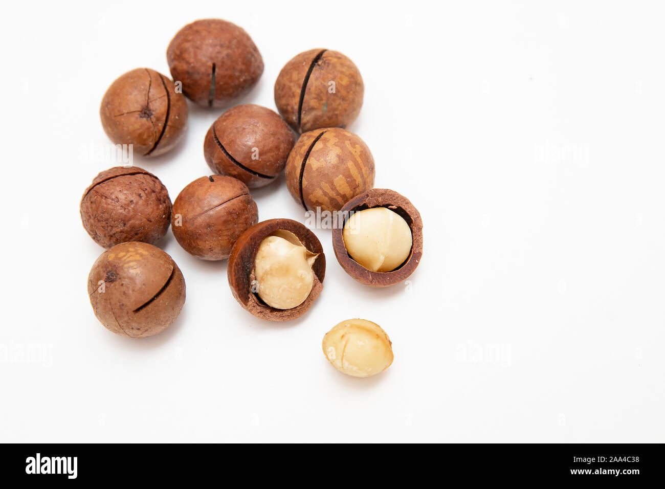 Pile macadamia nuts open kernels and shells on white background, top ...