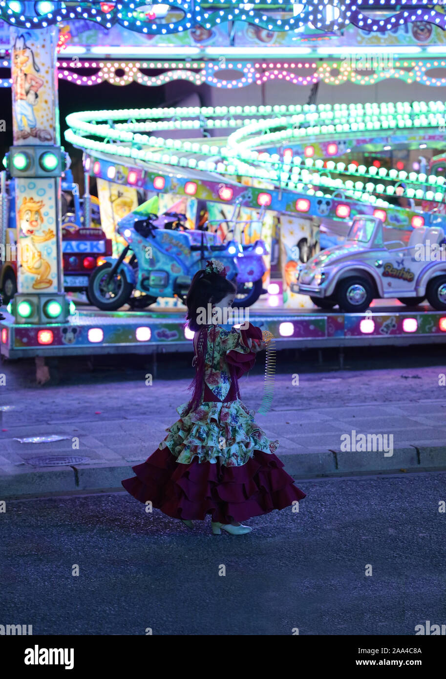 Fun Fair. Fairground rlde/stall. Girl in traditional Flamenco dress ...