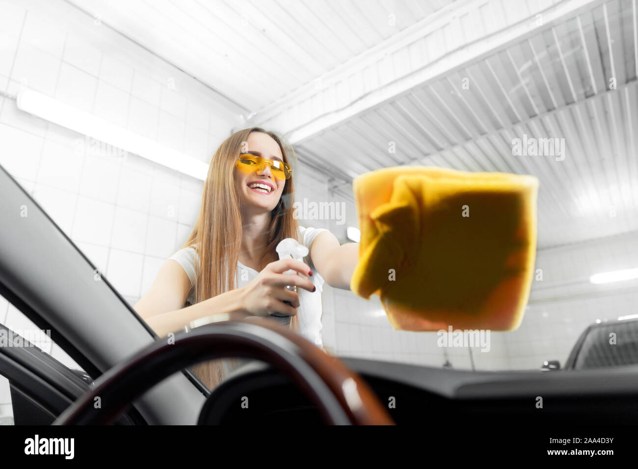 Beautiful women smiling washing car window clean spray Stock Photo - Alamy