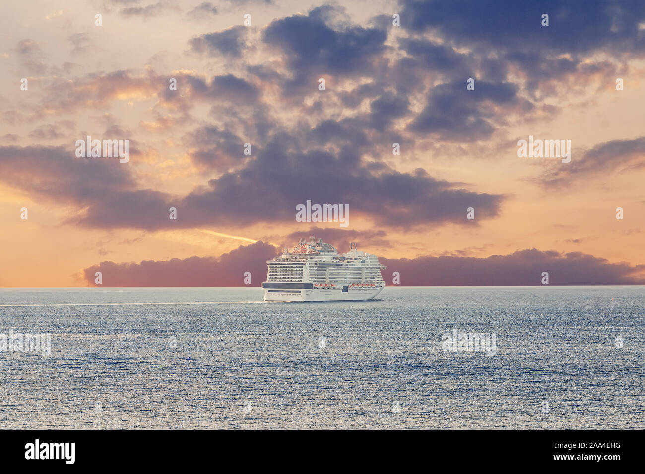 Luxury cruise ship sunset in blue sea with clouds Stock Photo - Alamy