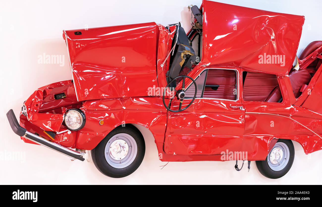 Flattened red retro car on the white background Stock Photo - Alamy