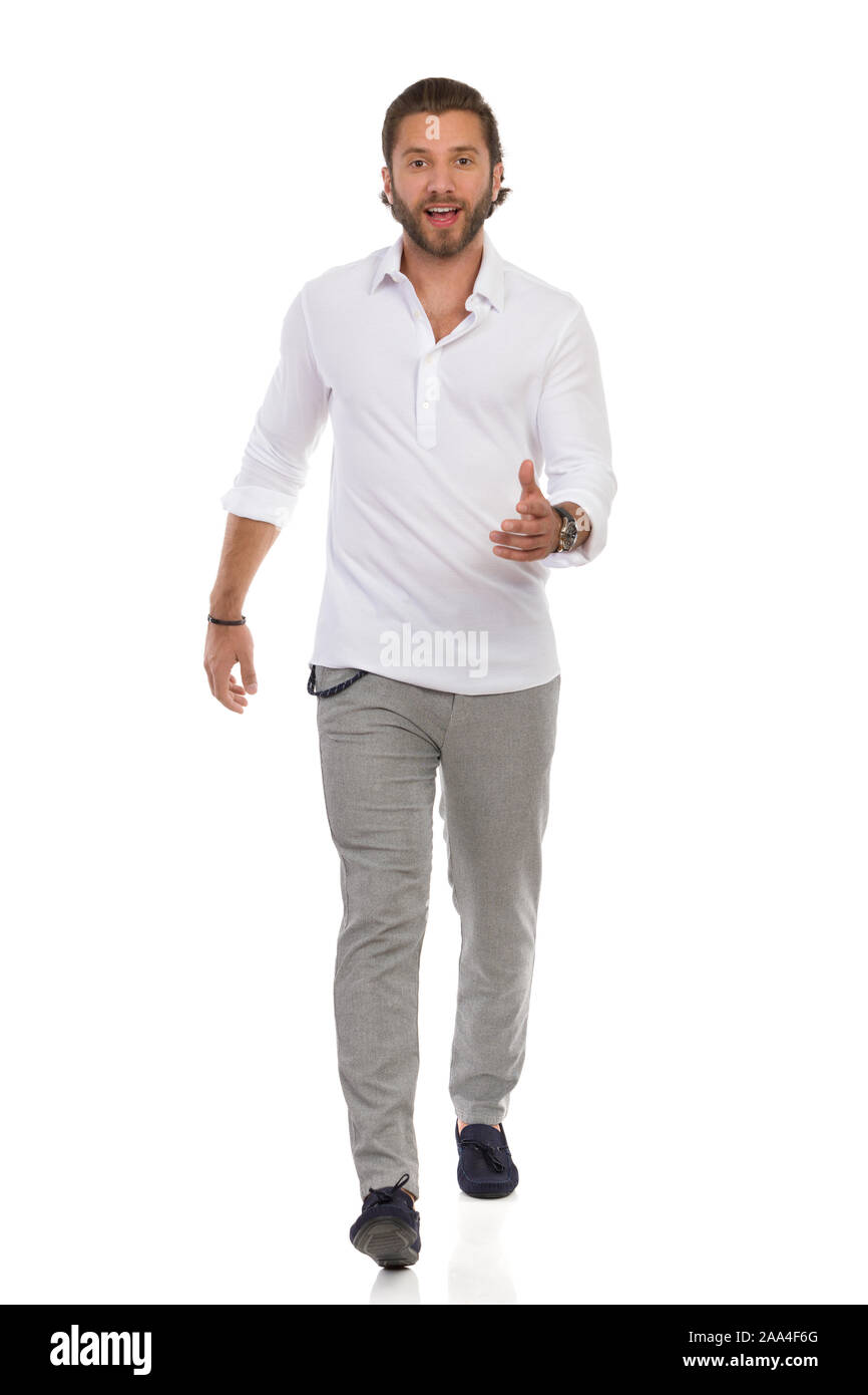Confident man is walking towards camera, looking at camera and talking ... Confident man is walking towards camera, looking at camera and talking ...