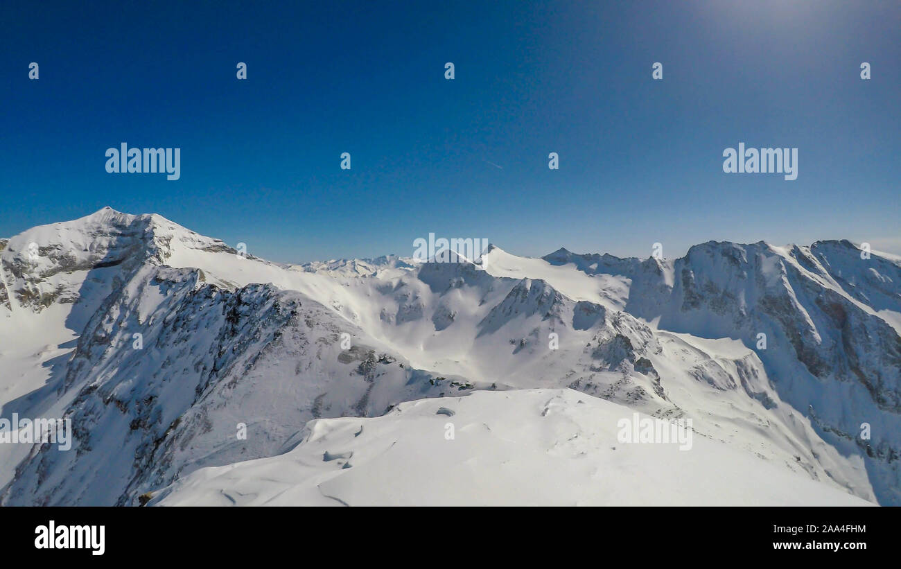 A beautiful and serene landscape of mountains covered with snow. Thick ...