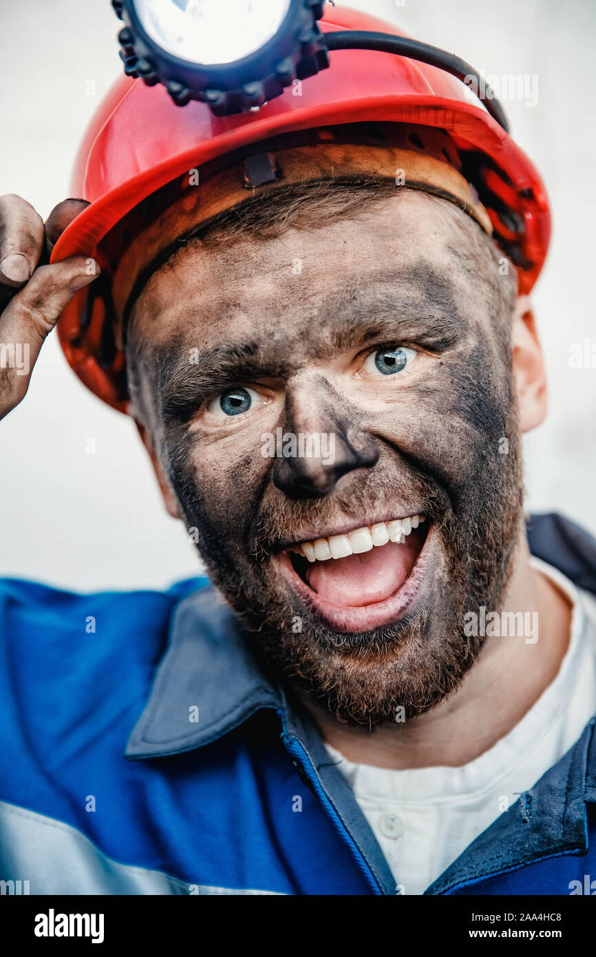 Miner happy man smiling after working on coal mine. Concept industrial ...