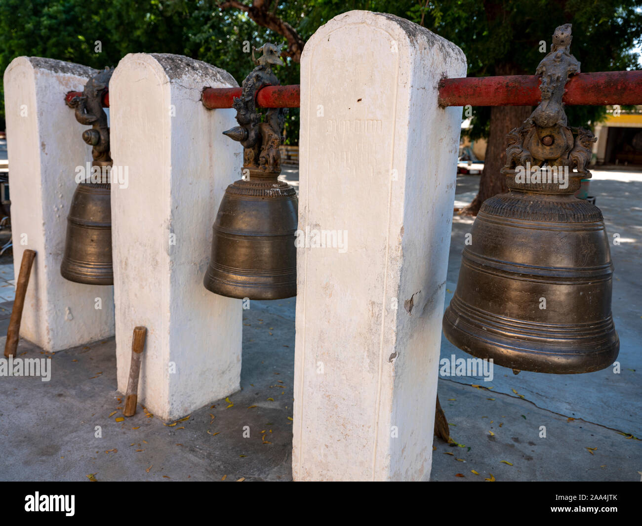 Three large hanging temple bells with mallets of the Shwezigon Pagoda ...
