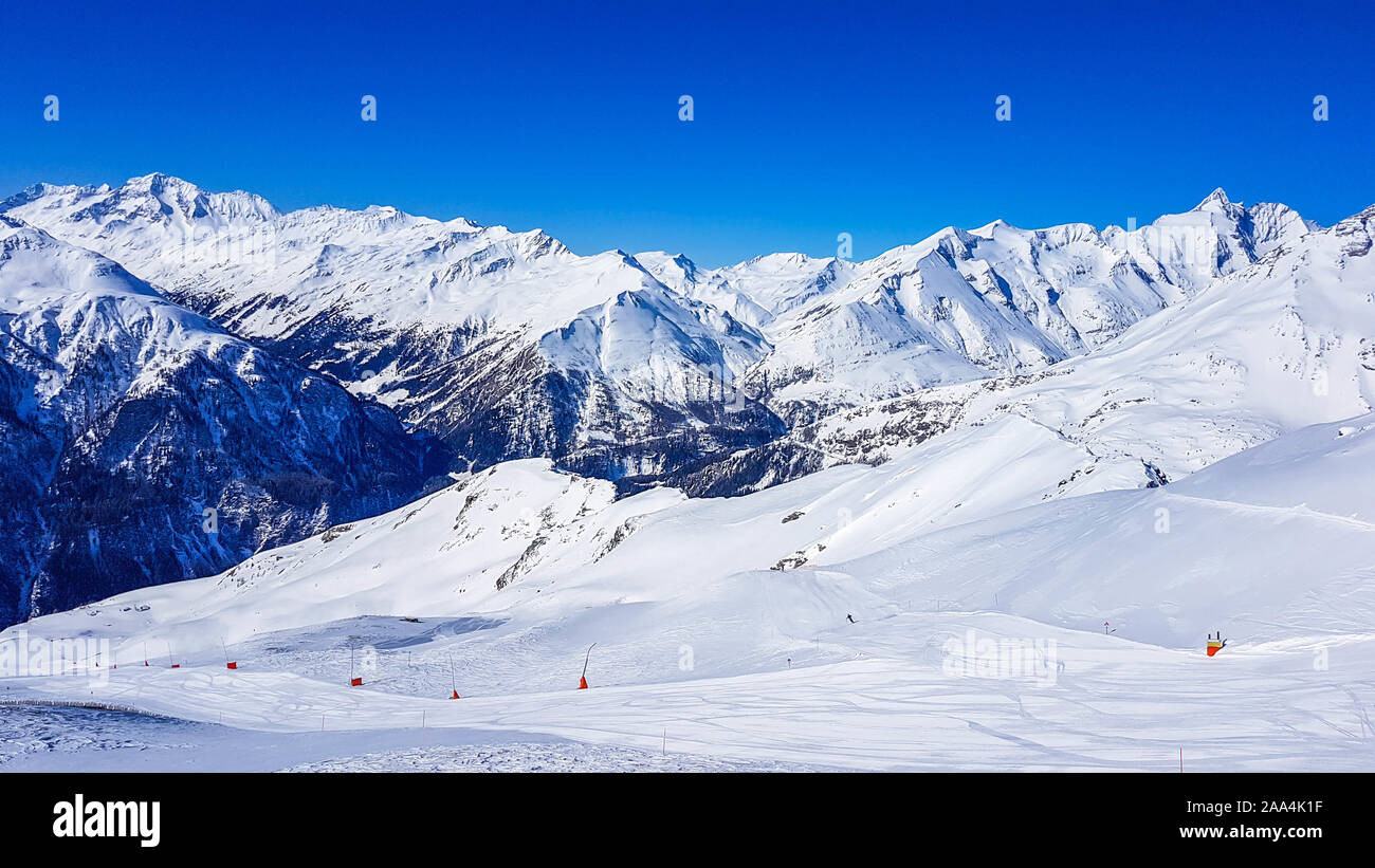 A beautiful and serene landscape of mountains covered with snow. Thick ...