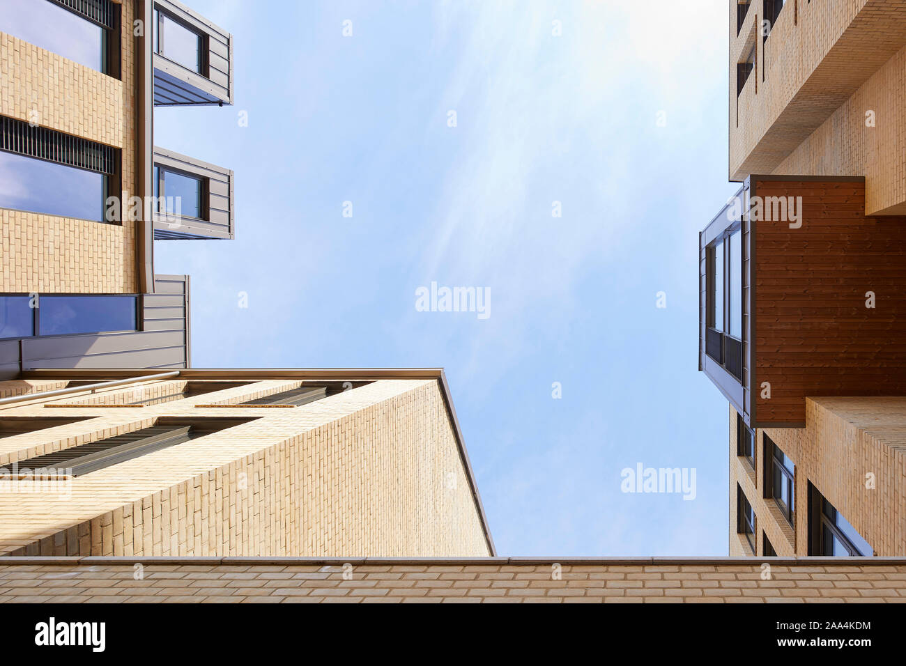 View towards sky along brick facades. Anglia House, Cambridge, United ...