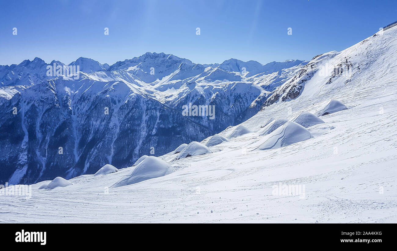 A beautiful and serene landscape of mountains covered with snow. Thick ...