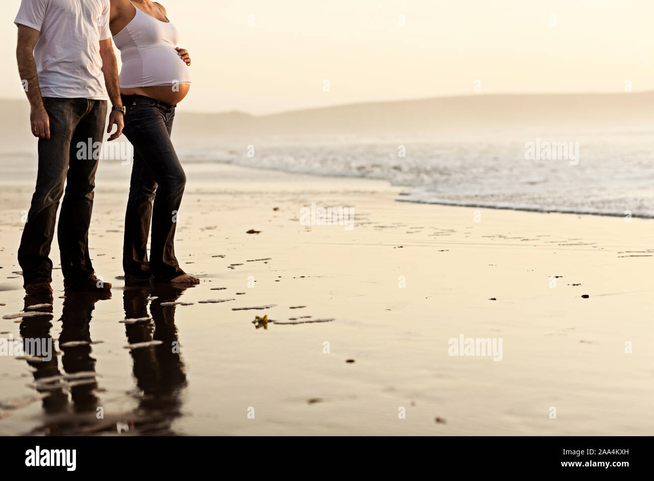 Expectant parents looking out to sea Stock Photo - Alamy