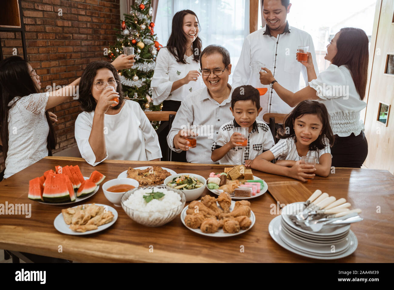 family cheering during lunch together at home Stock Photo - Alamy