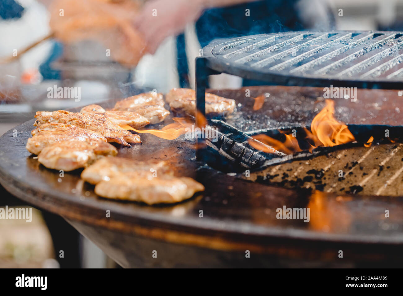 Pork ribs and steak cooked on grill, open fire street food festival ...
