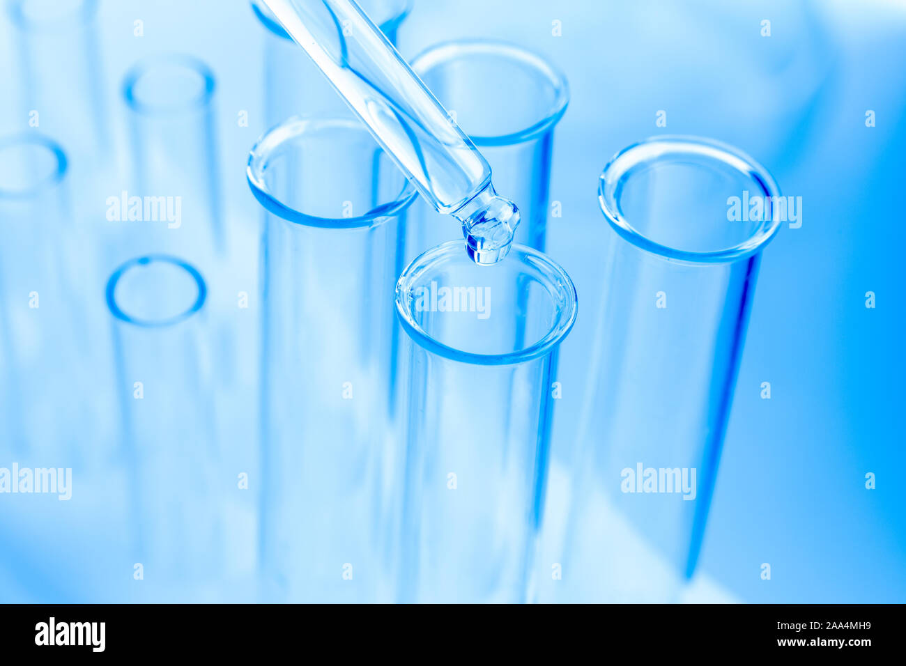 Chemical pipette dropper and test tube on blue background science Stock ...