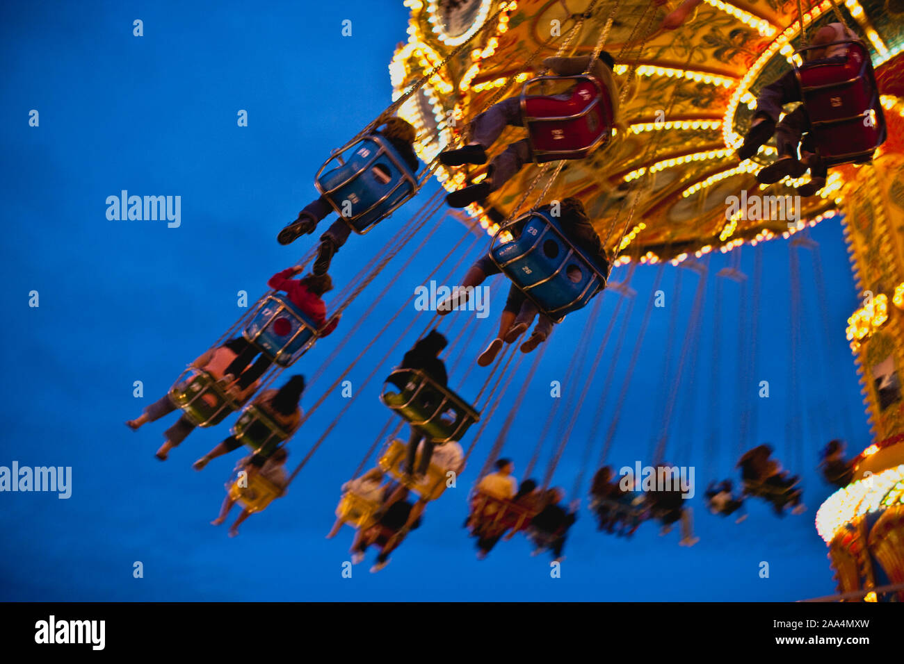 People on carnival swing ride Stock Photo - Alamy