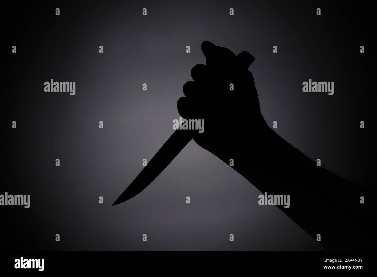 attacking with a knife / melee weapon shadow black silhouette in the ...