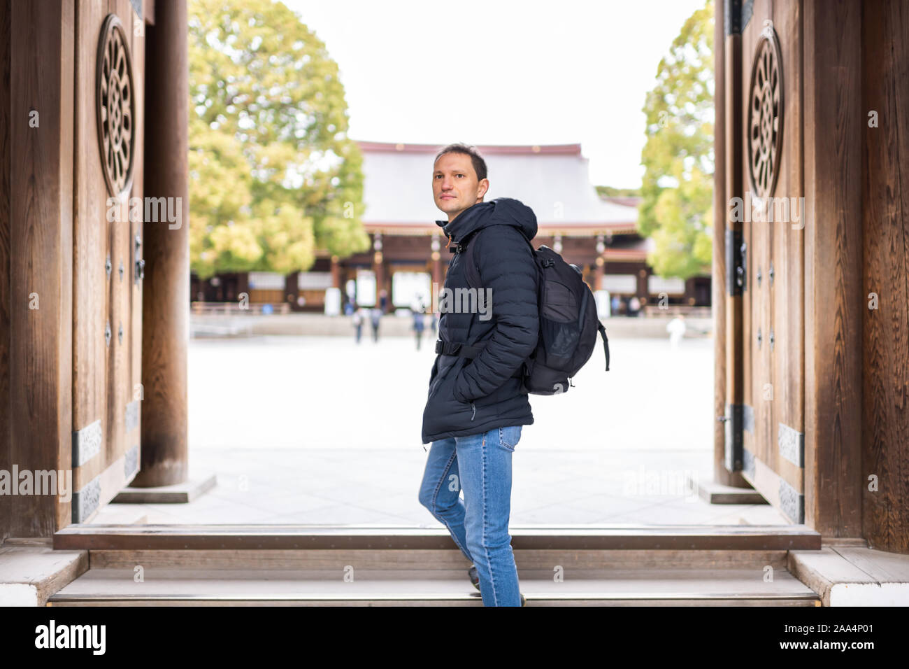 Tokyo, Japan Meiji shrine architecture with young tourist man standing ...