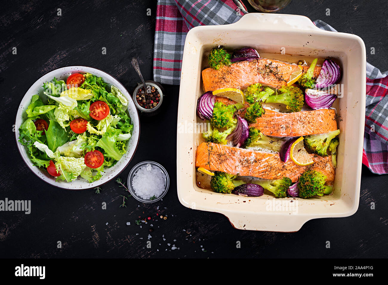 Baked salmon fillet with broccoli, red onion and lemon. Top view ...