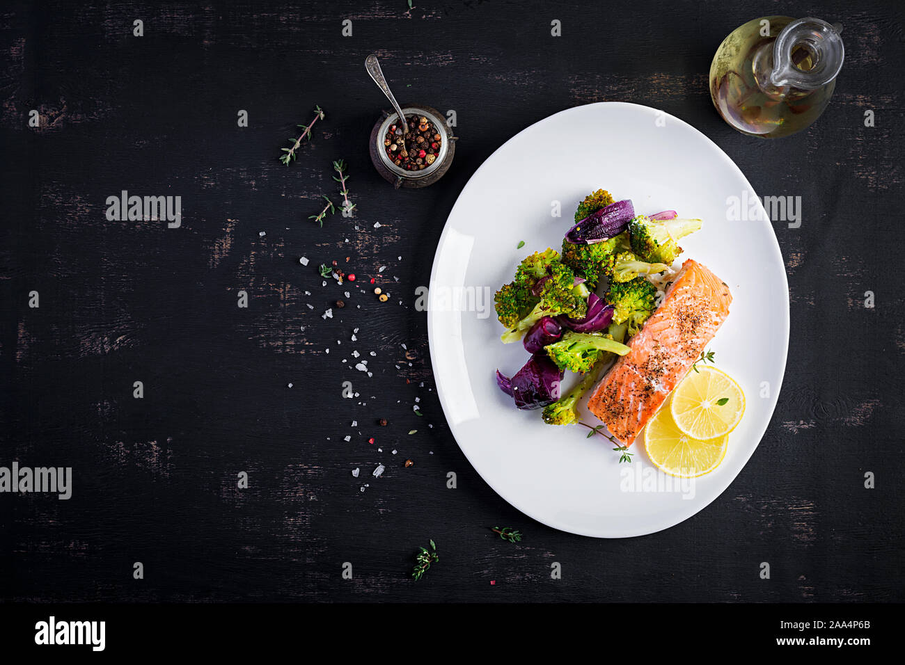Baked salmon fillet with broccoli, red onion and lemon. Top view ...