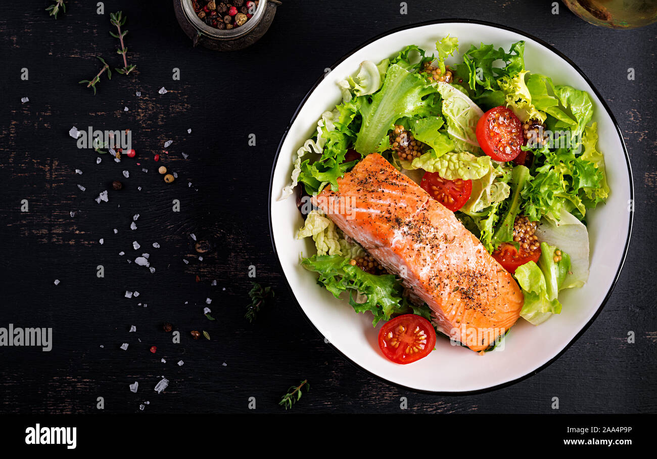 Baked salmon fillet with fresh vegetables salad. Top view, overhead ...