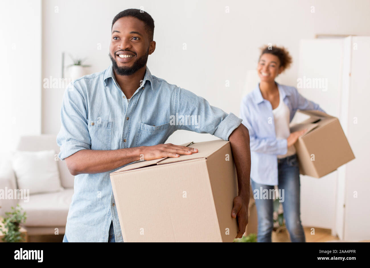 African American Spouses Carrying Moving Boxes Entering New Home Stock ...
