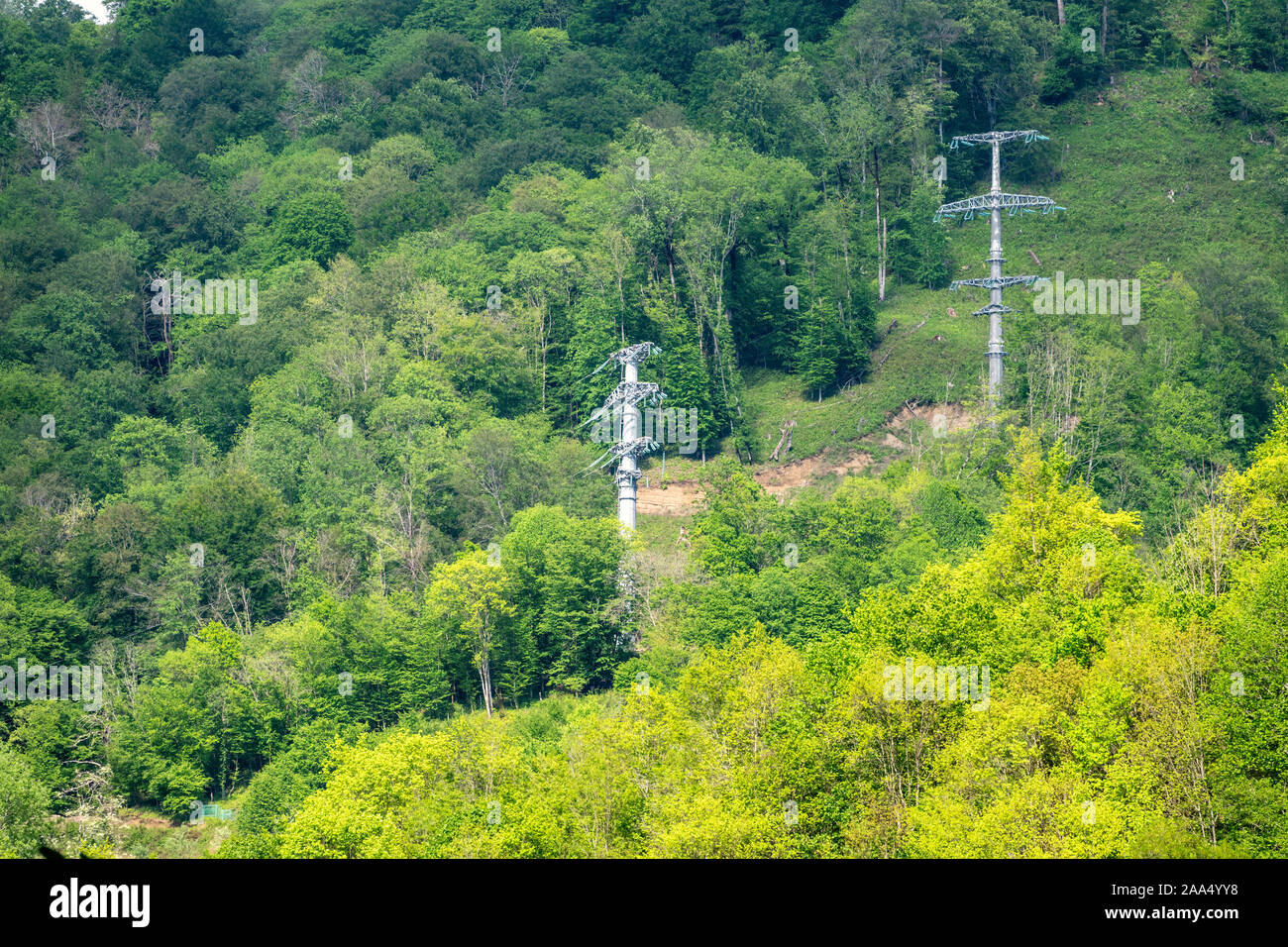Power lines on a mountain green slope. Overhead power line in the ...