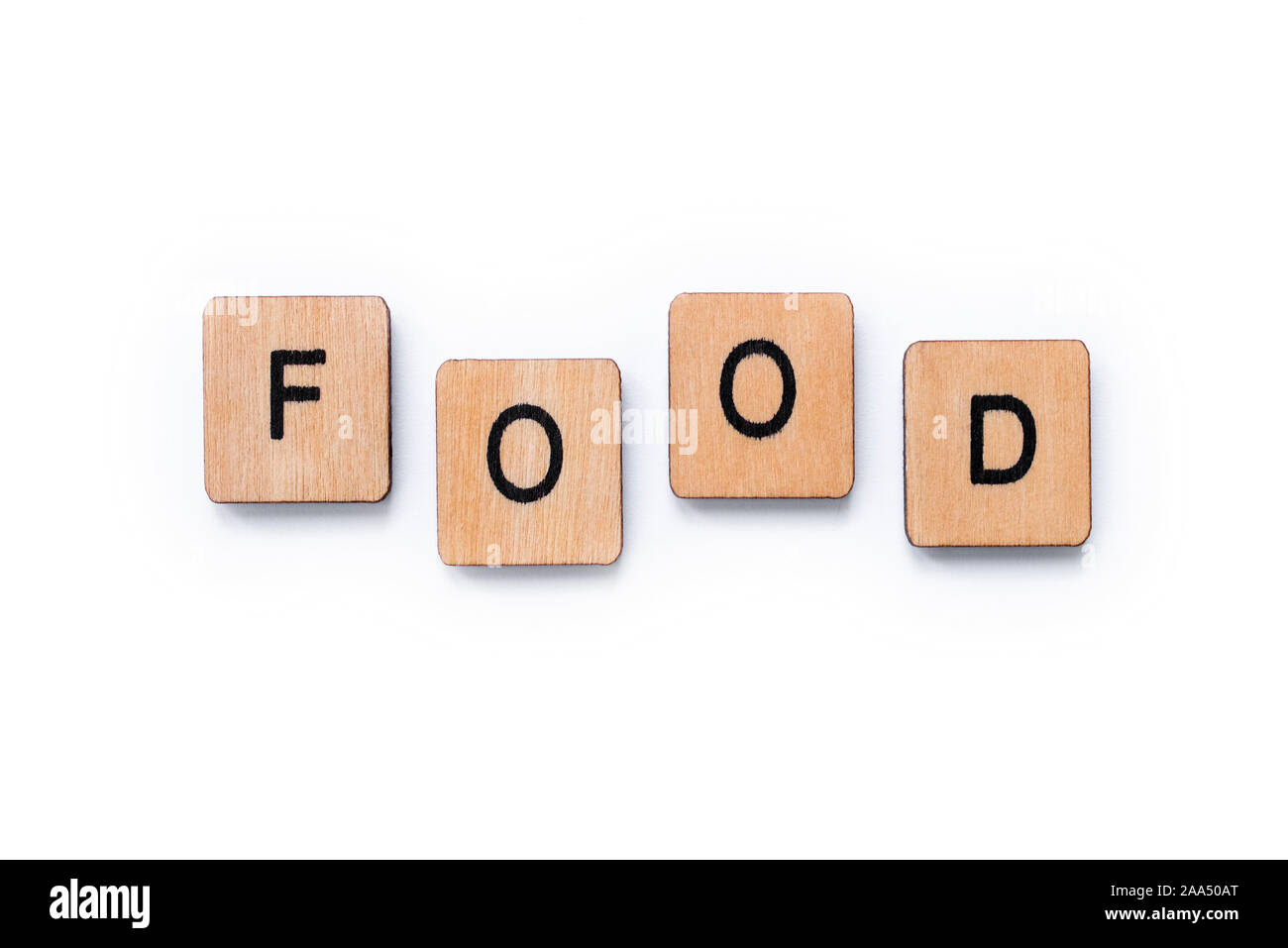 The word FOOD, spelt with wooden letter tiles over a white background ...