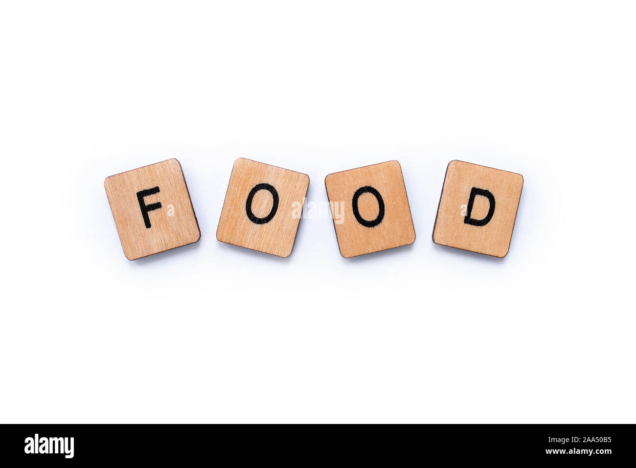 The word FOOD, spelt with wooden letter tiles over a white background ...