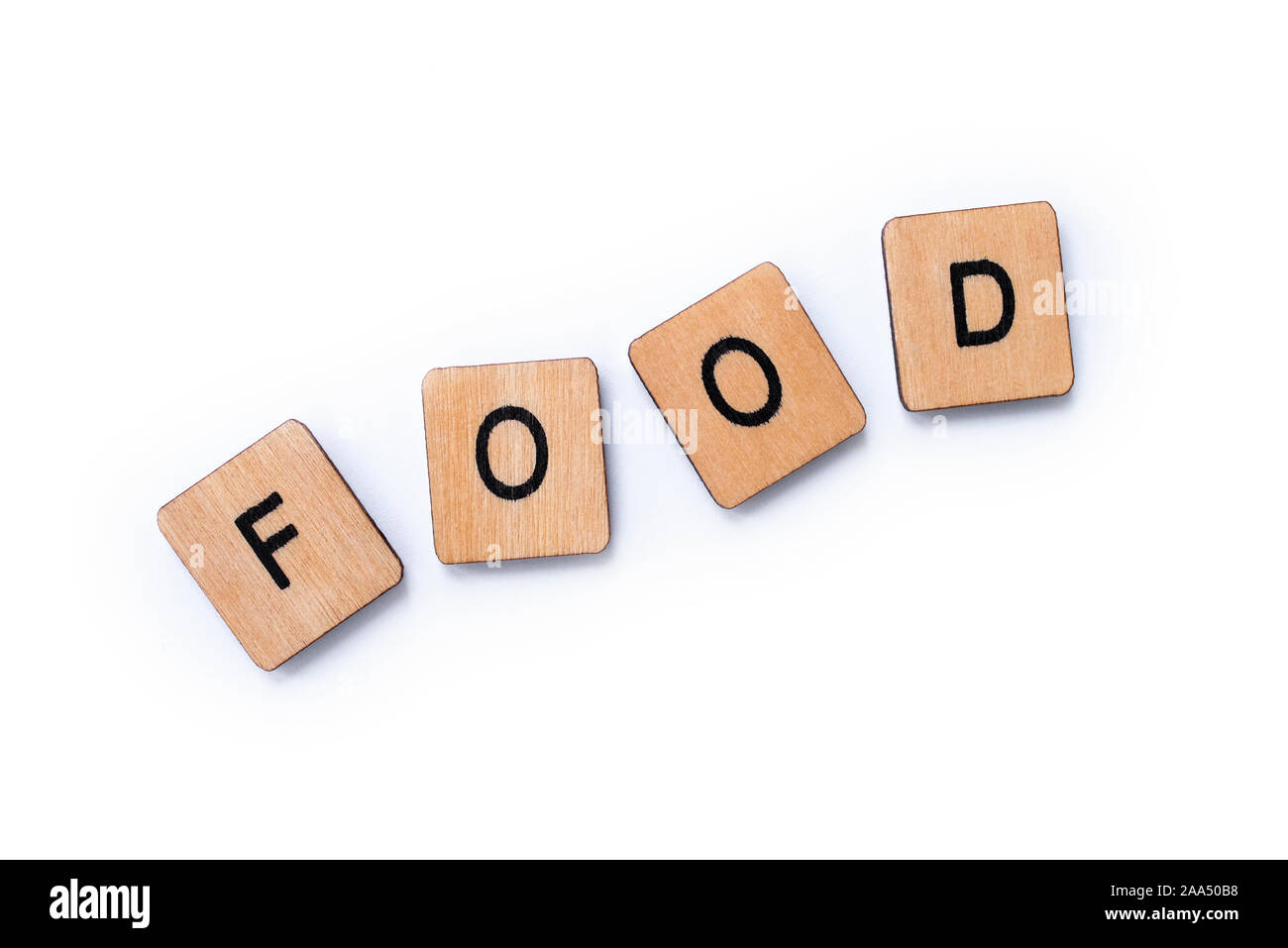 The word FOOD, spelt with wooden letter tiles over a white background ...