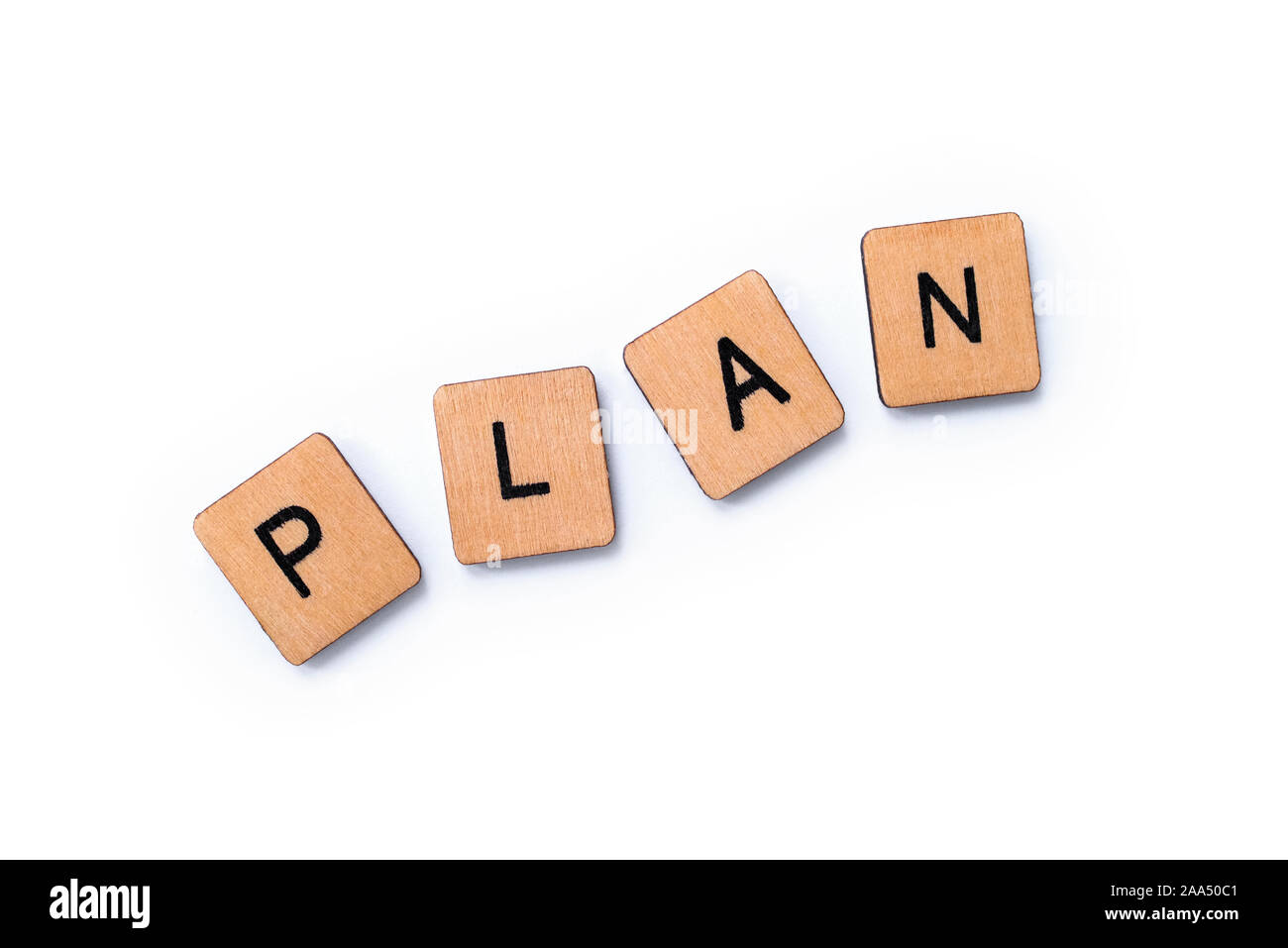 The word PLAN, spelt with wooden letter tiles over a white background ...