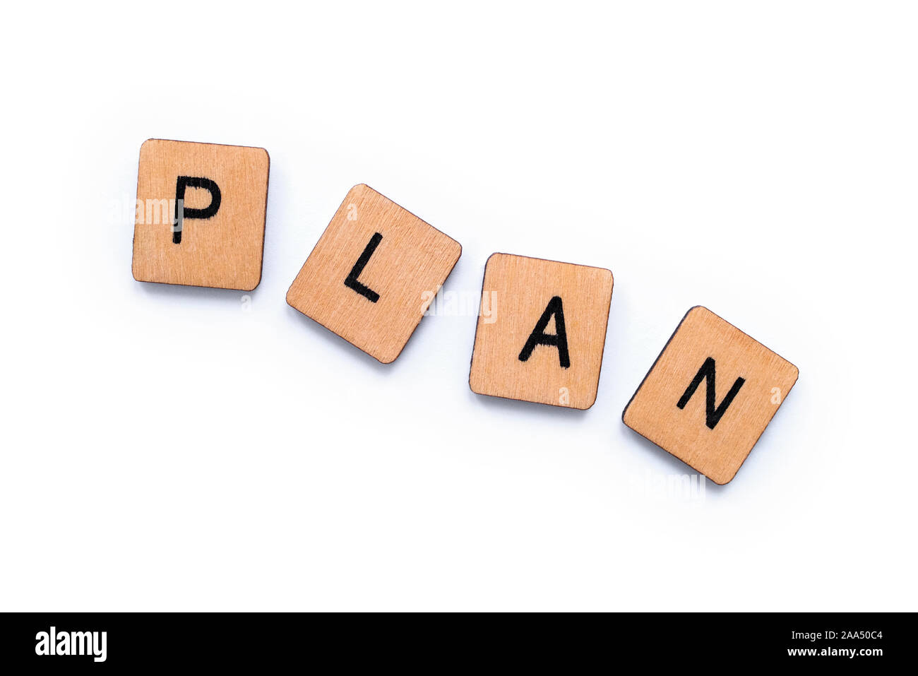 The word PLAN, spelt with wooden letter tiles over a white background ...