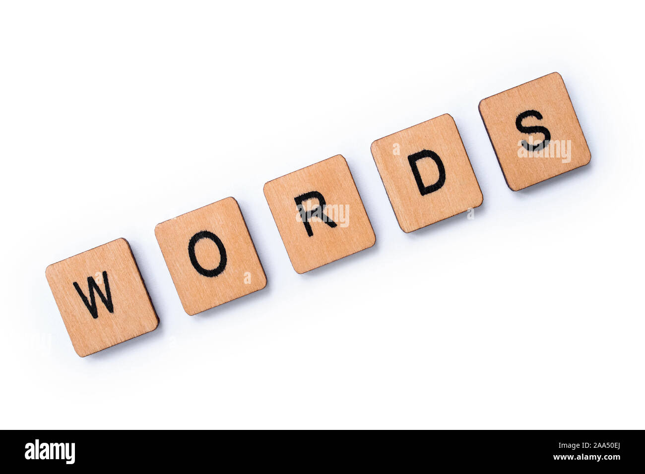 The word WORDS, spelt with wooden letter tiles over a white background ...