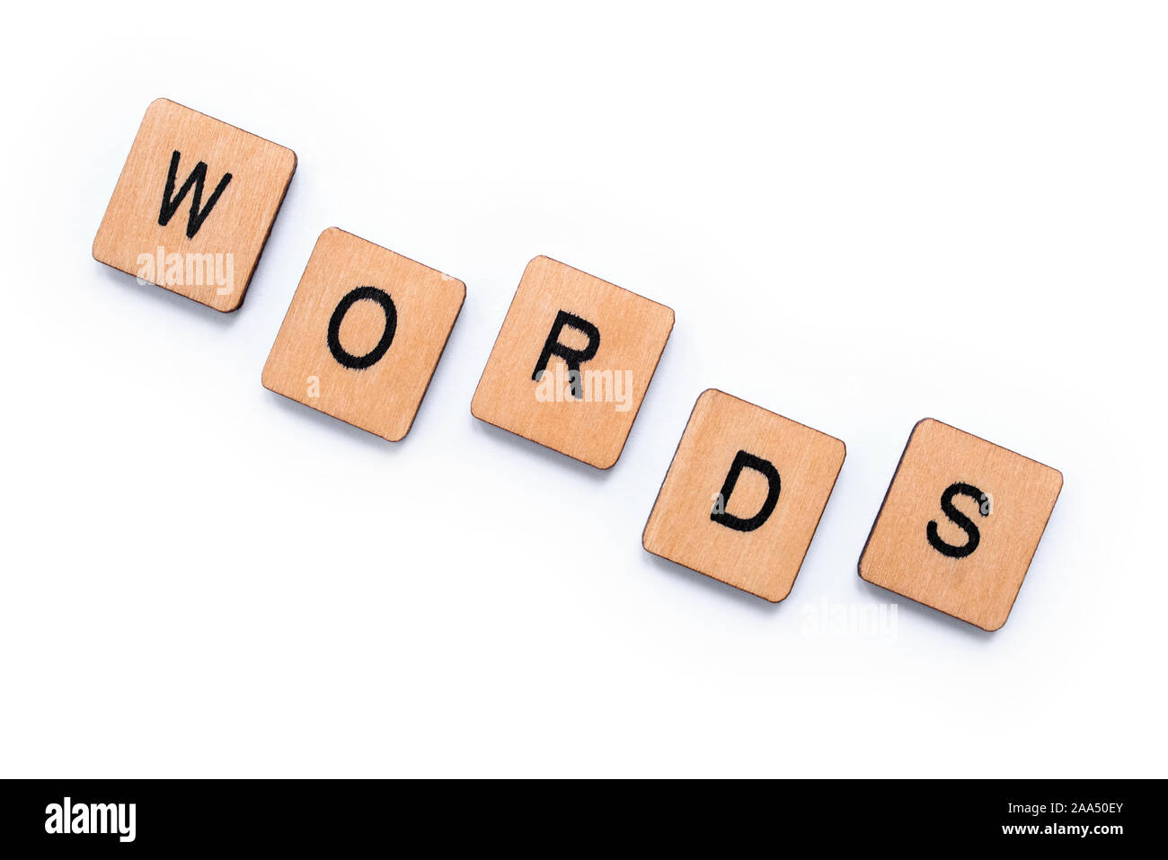 The word WORDS, spelt with wooden letter tiles over a white background ...